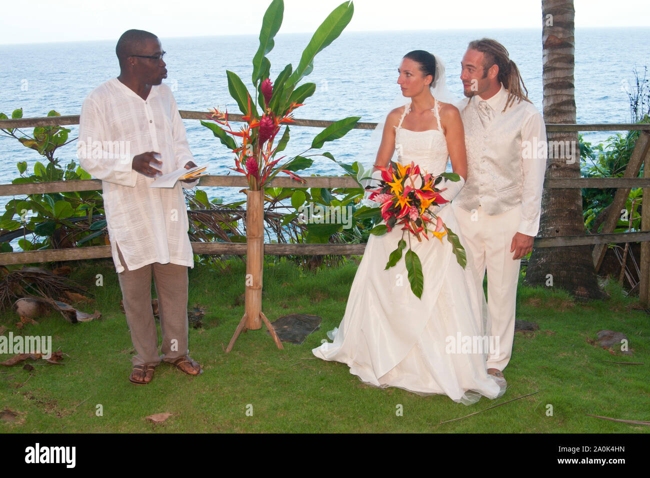A French couple is getting married outdoors near the ocean in Dominicia ...