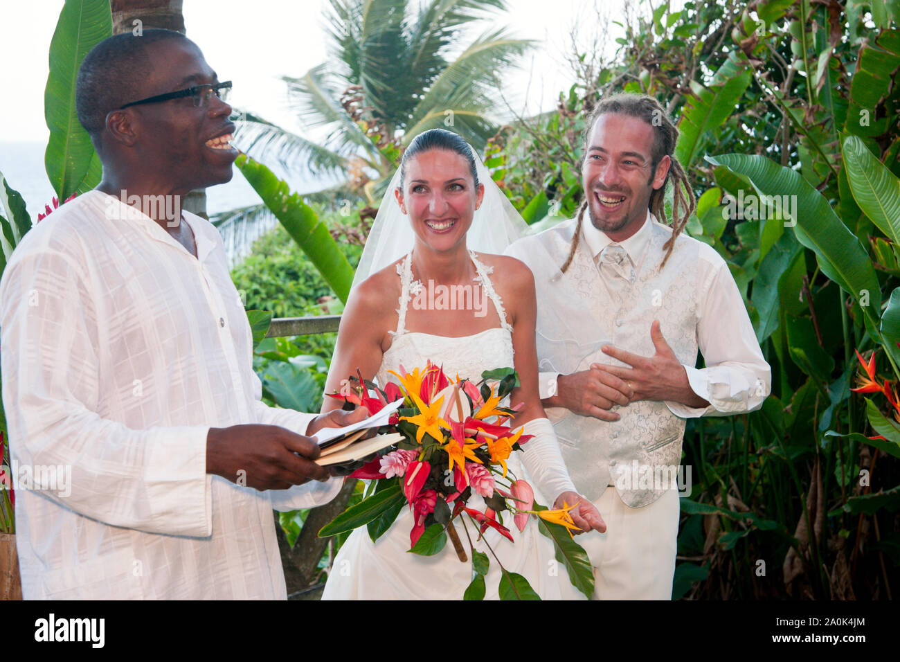 A French couple is getting married outdoors near the ocean in Dominicia ...
