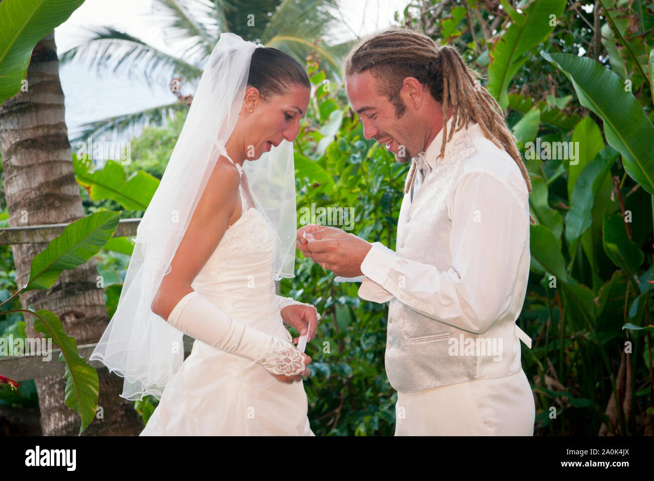 A French couple is getting married outdoors near the ocean in Dominicia ...