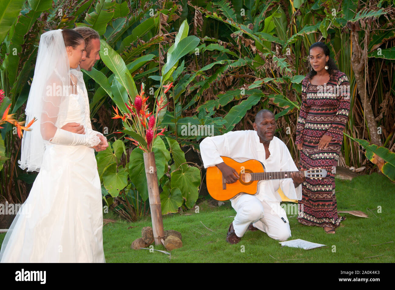 A French couple is getting married outdoors near the ocean in Dominicia ...