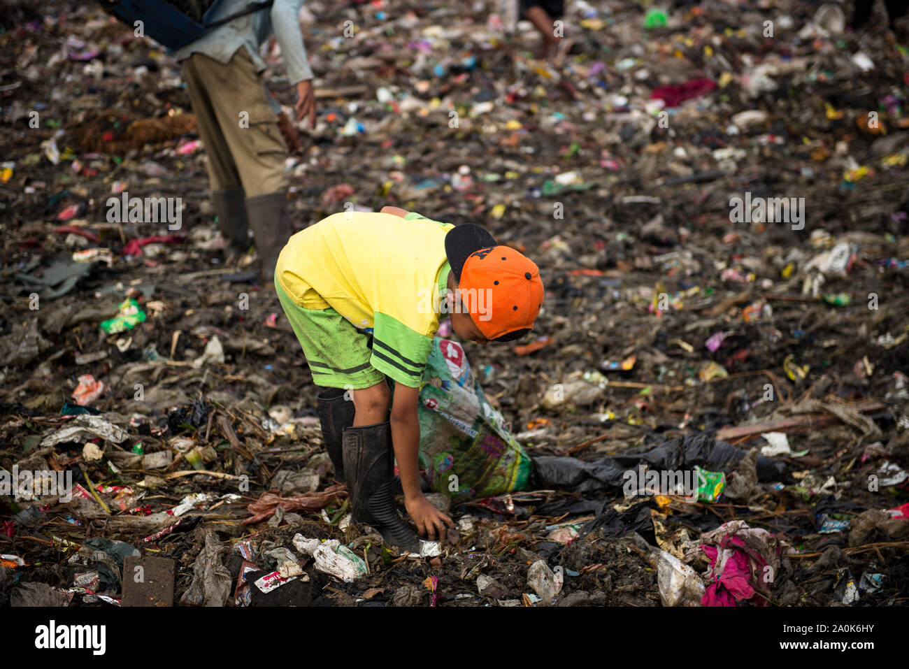 A minor child working as a garbage collector at the landfill Stock ...