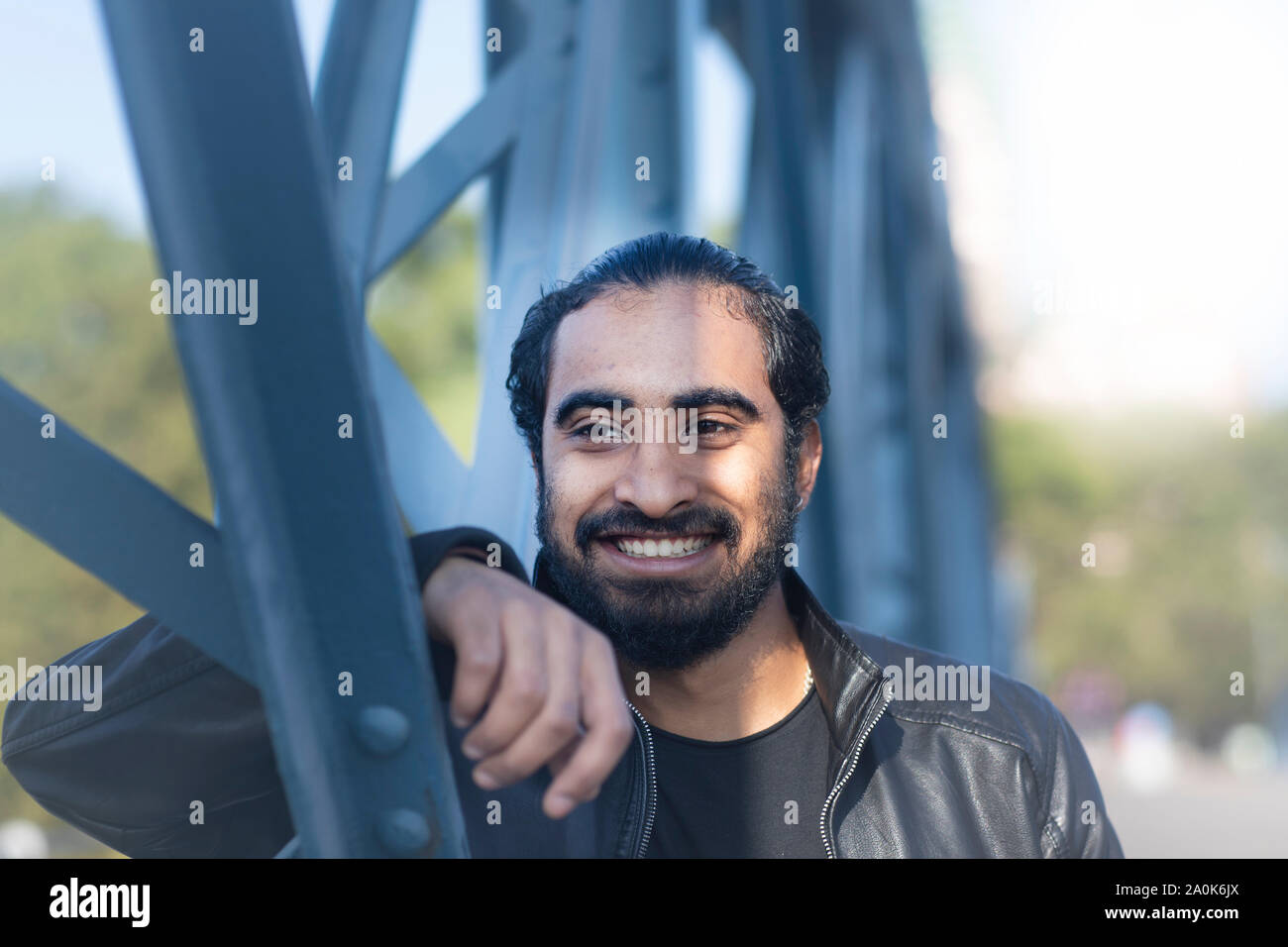 young man with braid and beard on a steel bridge Stock Photo - Alamy