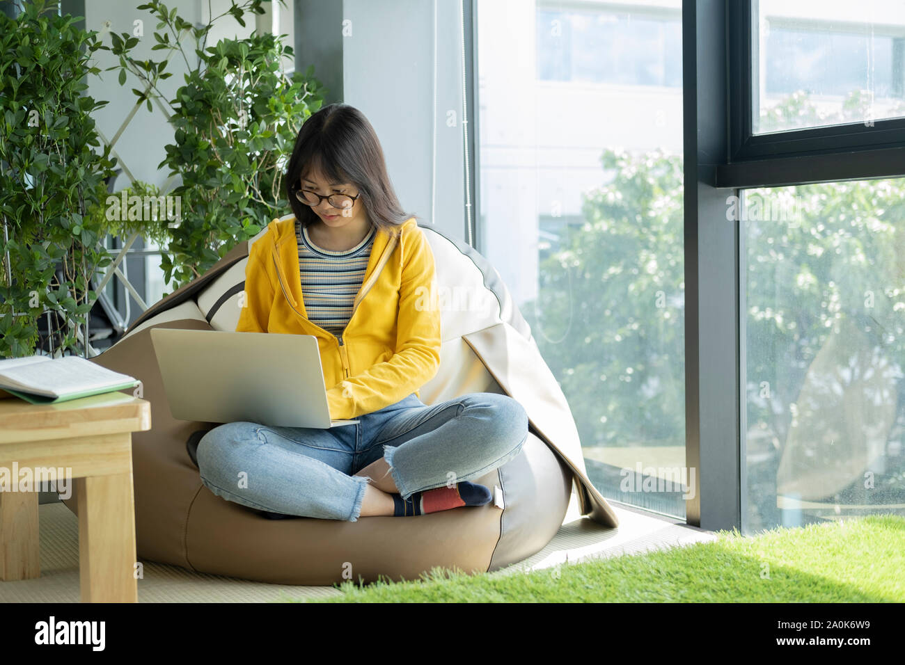 Young collage student using computer and mobile device studying online ...