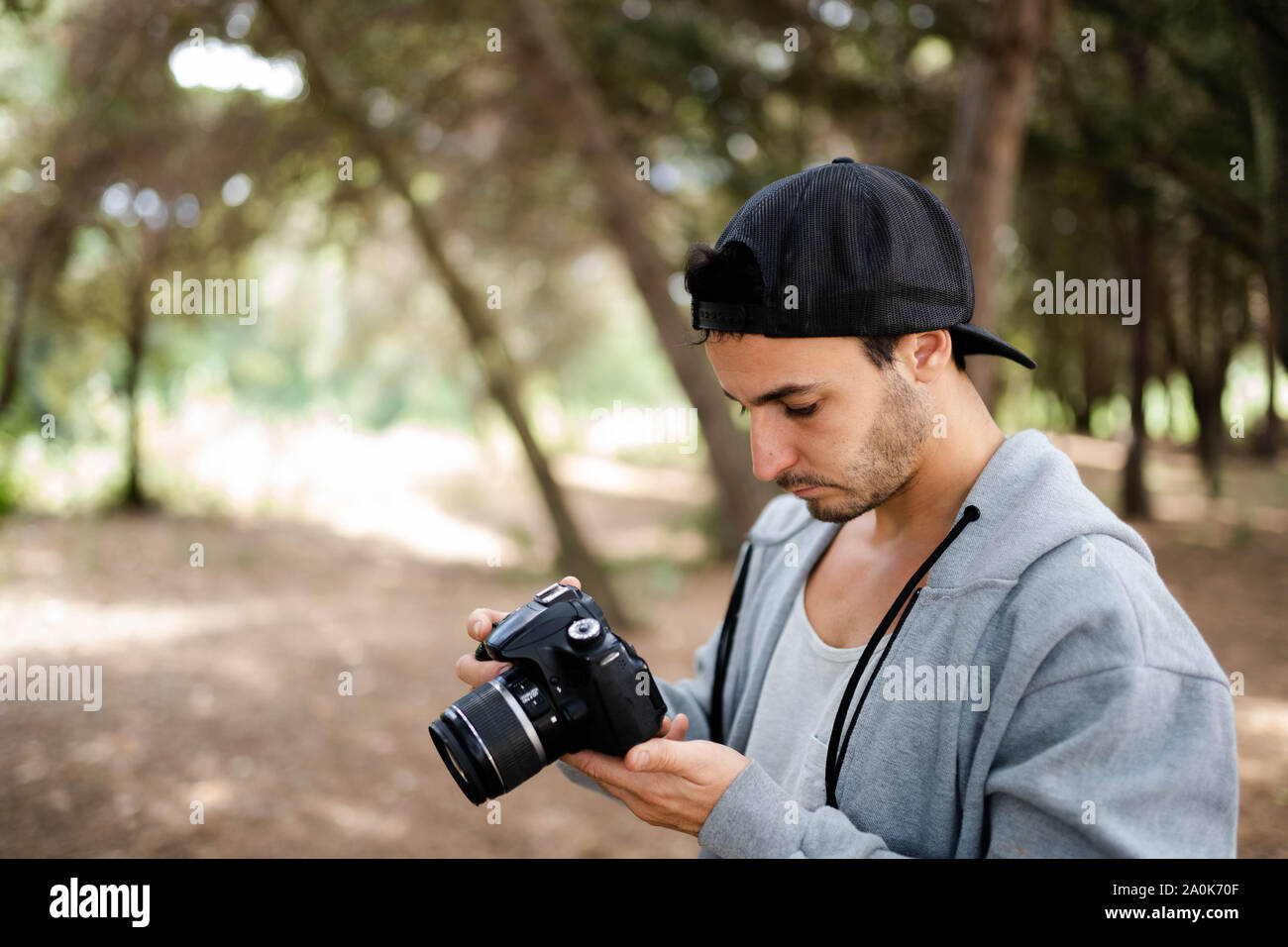 man working as a photographer shooting pictures and video editing Stock ...