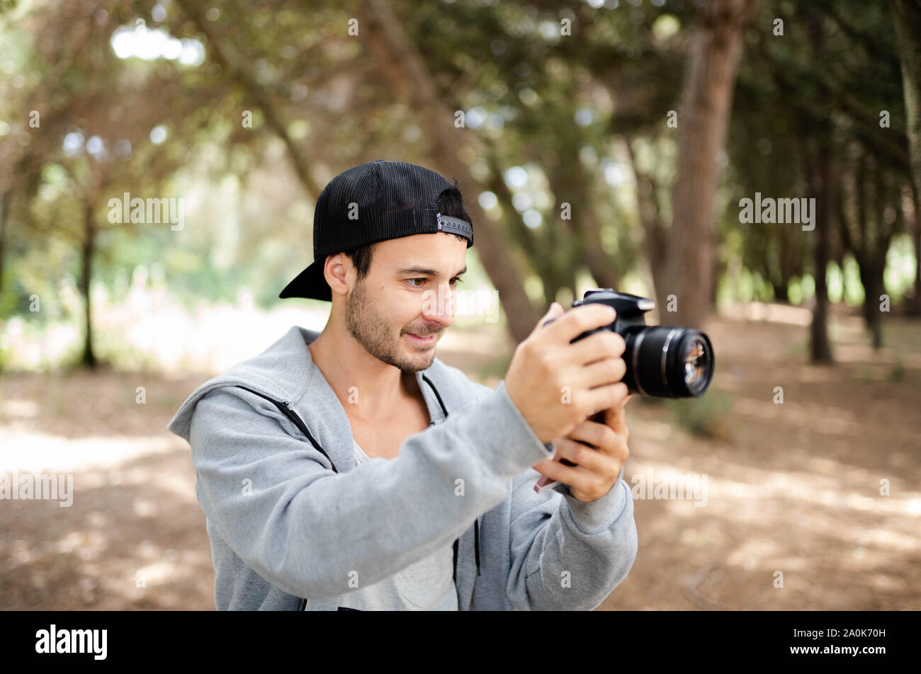 man working as a photographer shooting pictures and video editing Stock ...