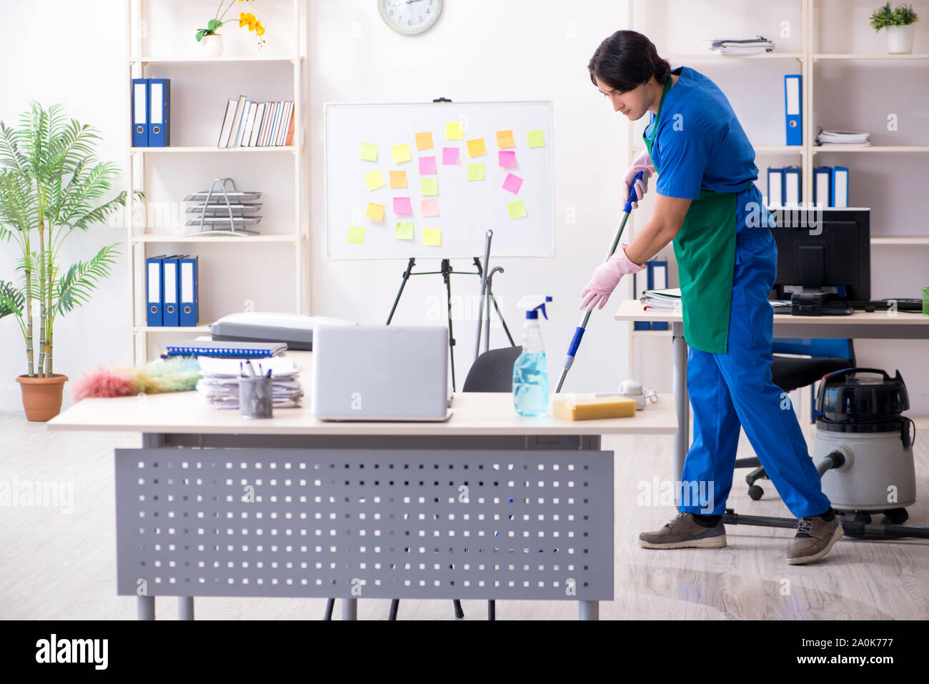 The male handsome professional cleaner working in the office Stock ...