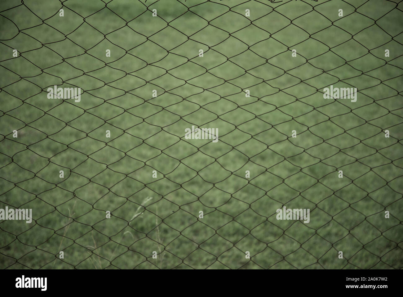 Fence with grass field background Stock Photo - Alamy