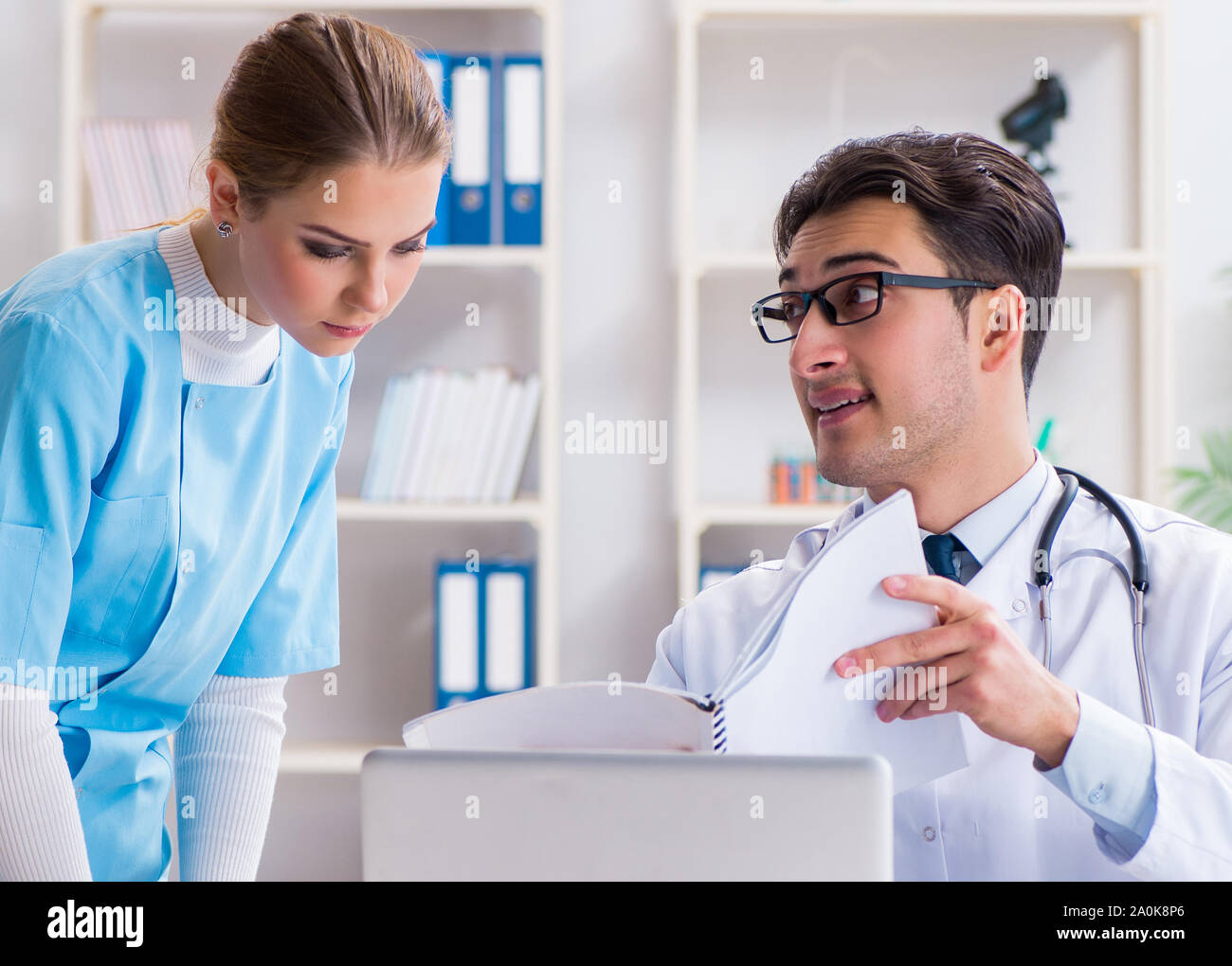 Male doctor showing female trainee hi-res stock photography and images ...