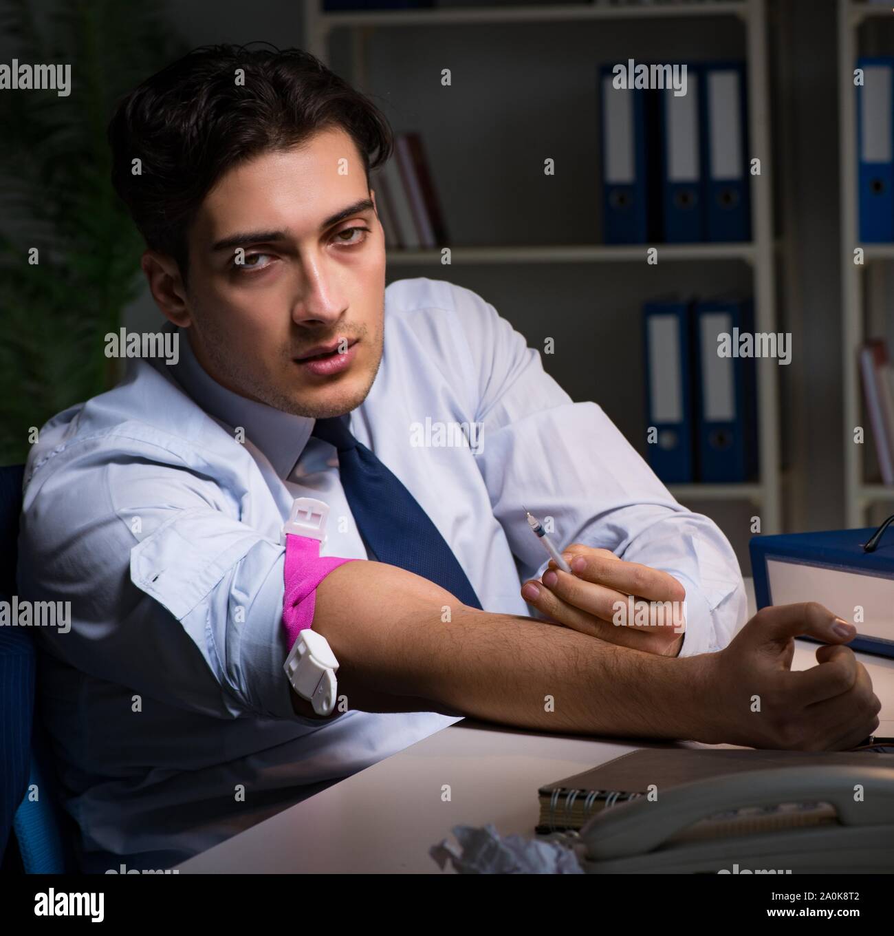 The employee relieving stress from overtime with drugs narcotics Stock ...