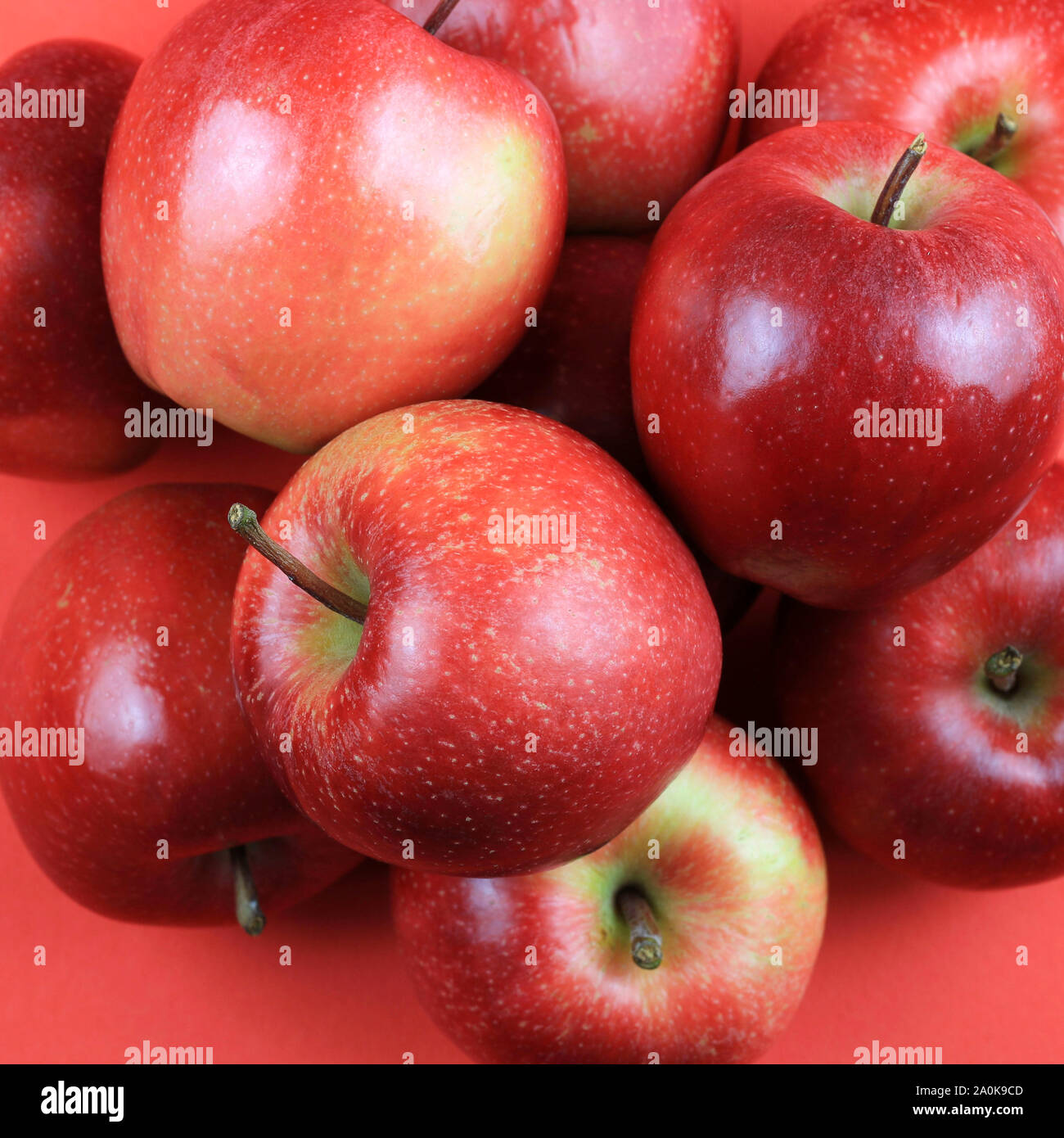 Fresh red apples on red background. Top view Stock Photo - Alamy