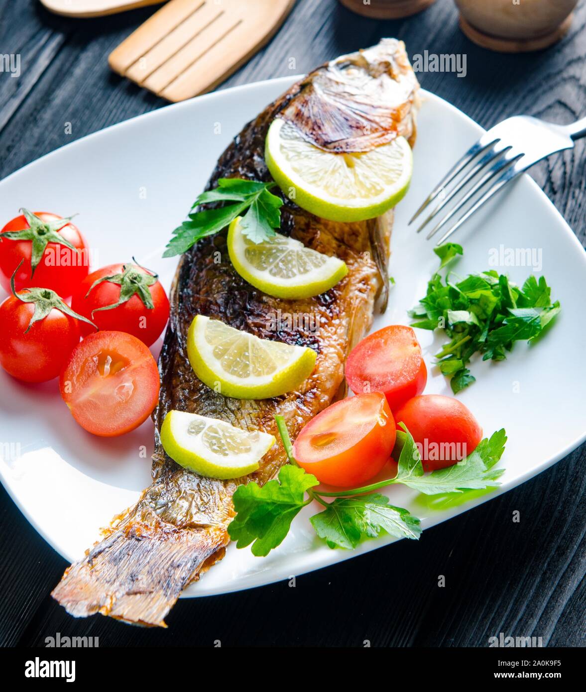 The fried fish served on the plate Stock Photo - Alamy