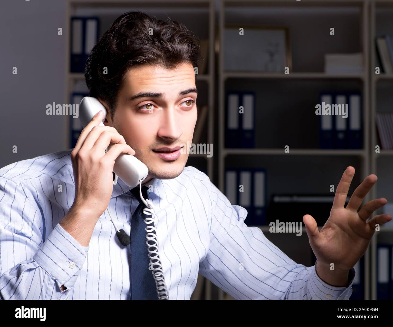 The tired and exhausted helpdesk operator during night shift Stock ...