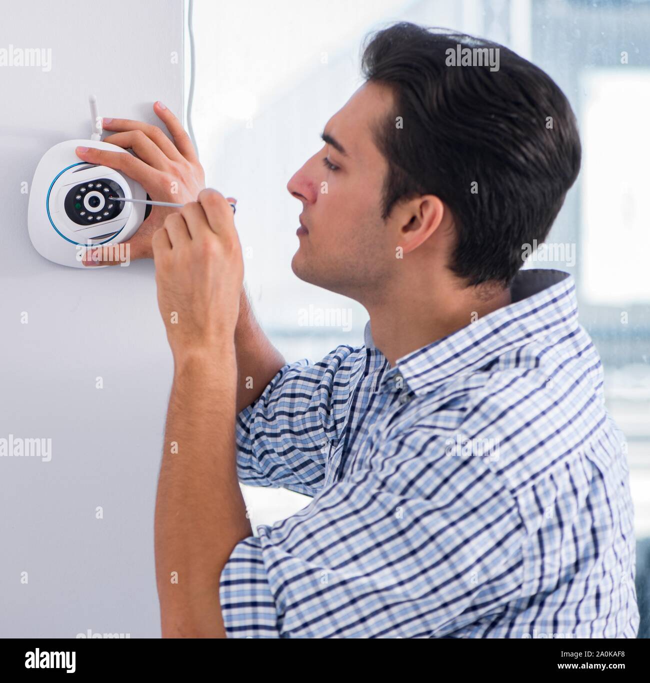 The man installing surveillance cctv cameras at home Stock Photo - Alamy