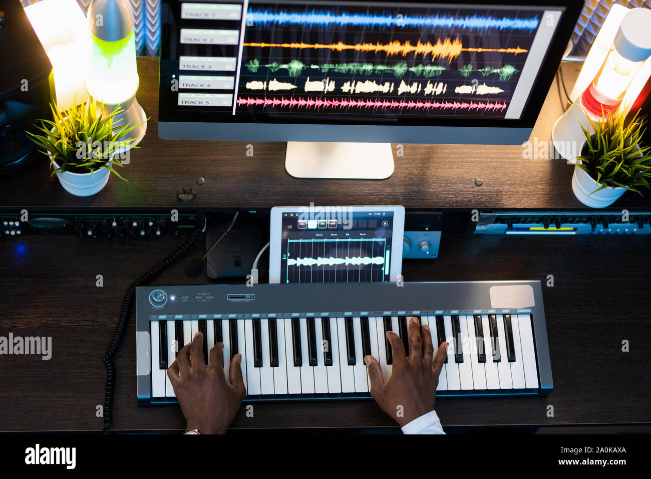 Human hands on keys of piano keyboard during process of recording new ...