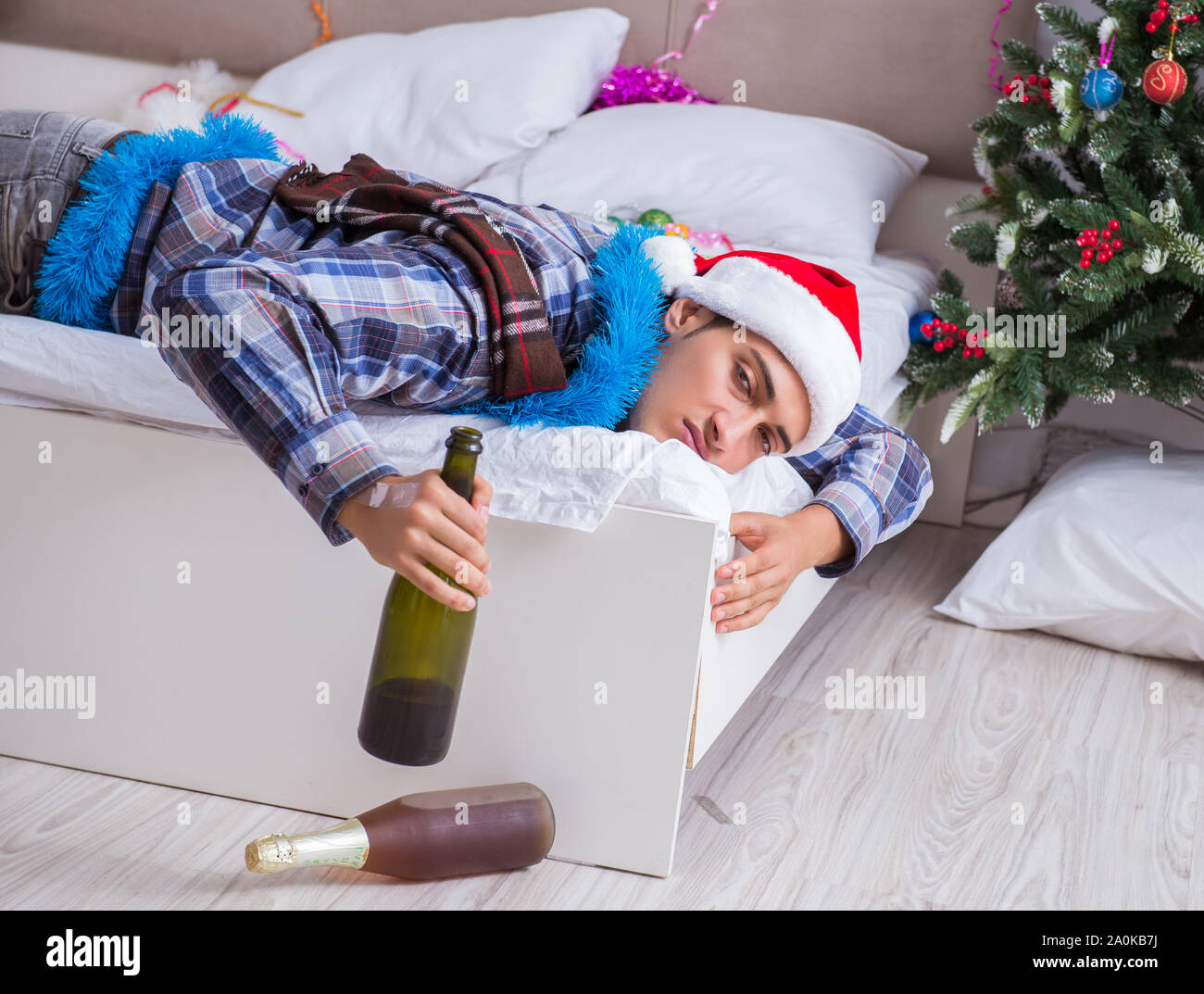 The man suffering hangover after christmas party Stock Photo - Alamy