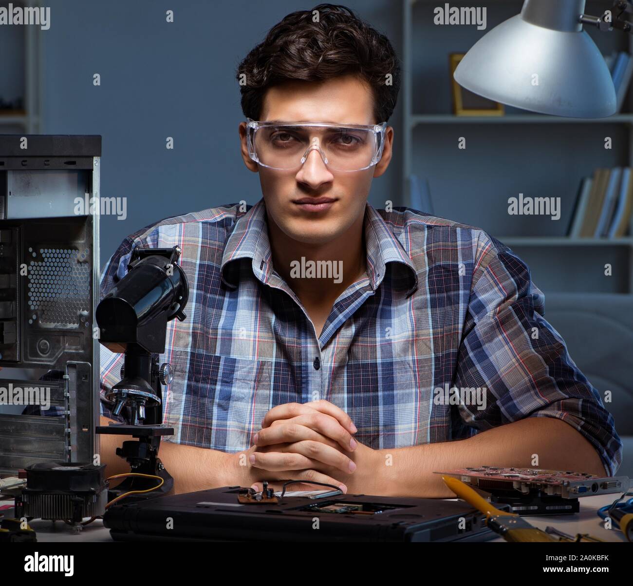 The computer repair man cleaning dust with brush Stock Photo - Alamy