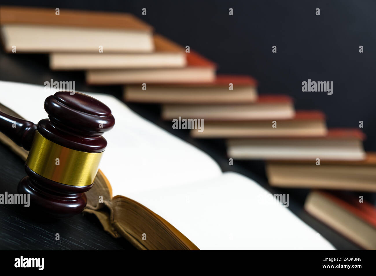 Judge gavel beside pile of books Stock Photo - Alamy