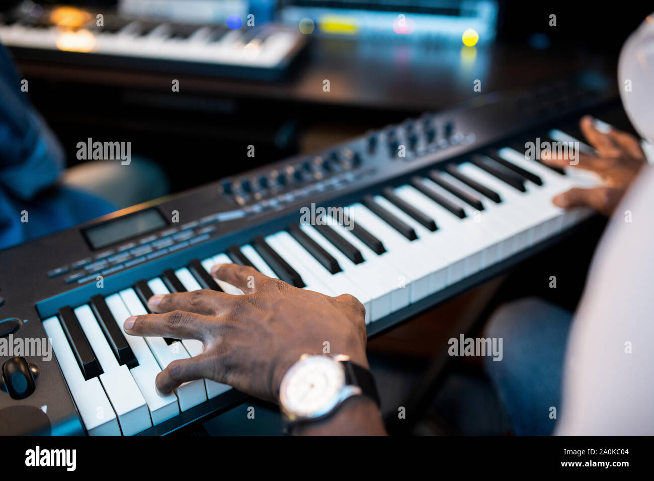Hands of young African composers or musician touching keys of ...