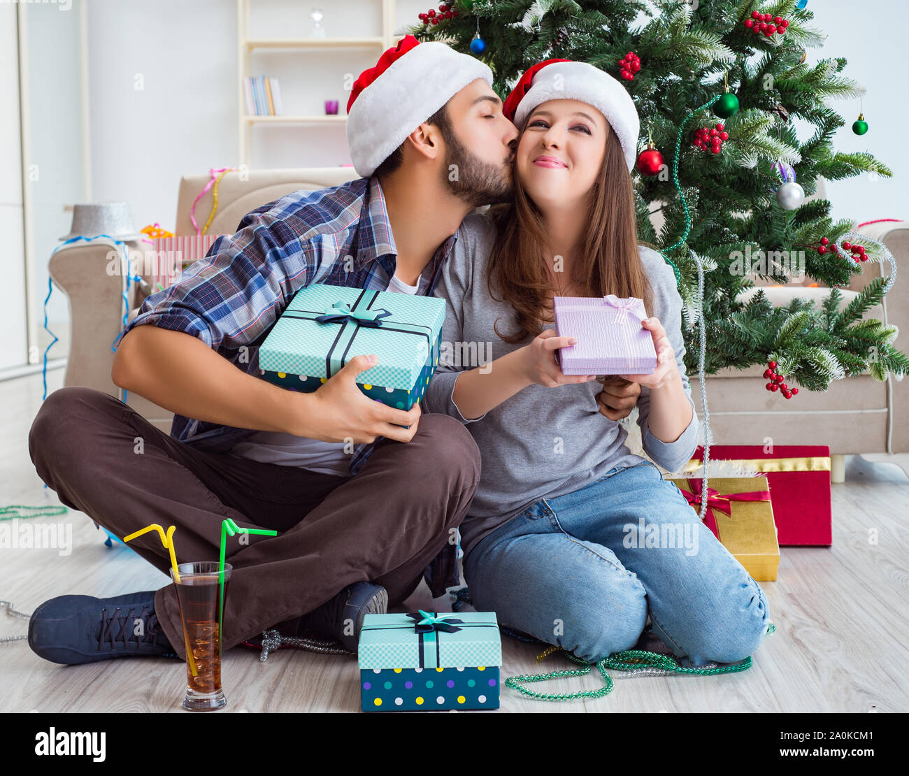 The girlfriend and boyfriend opening christmas gifts Stock Photo - Alamy