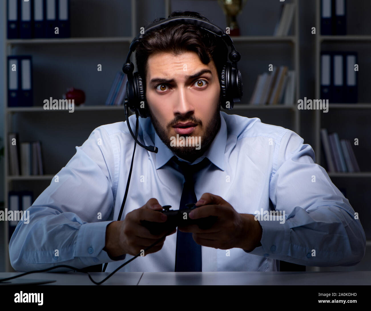 The businessman gamer staying late to play games Stock Photo - Alamy