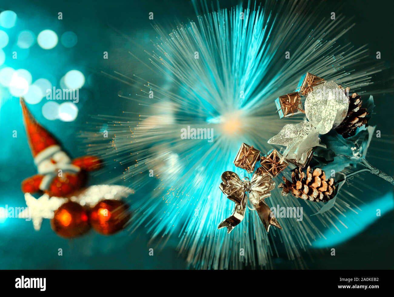 Christmas decorations and blurred santa on light rays in a blue ...