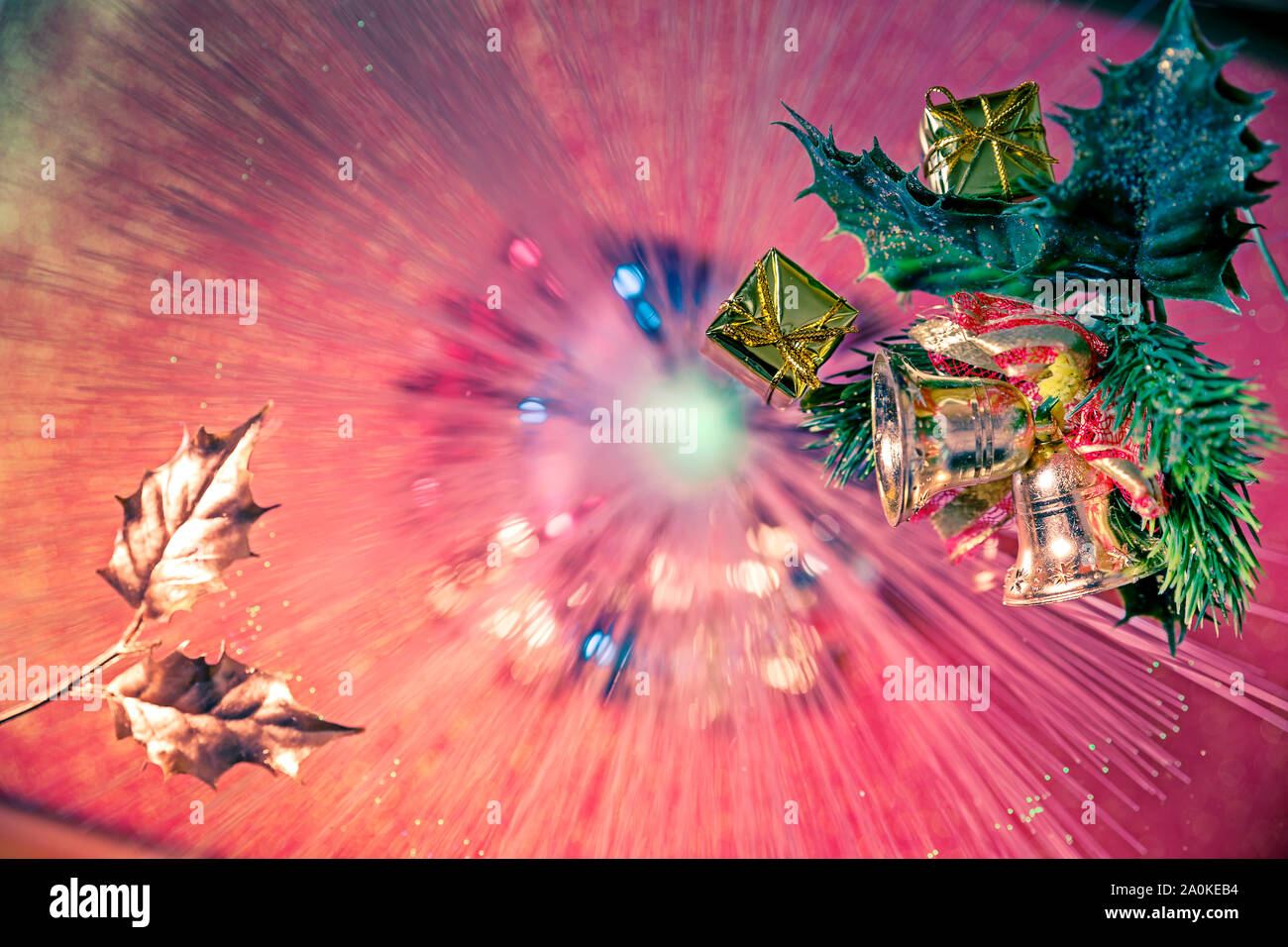 Christmas decorations and blurred santa on light rays in a pink ...