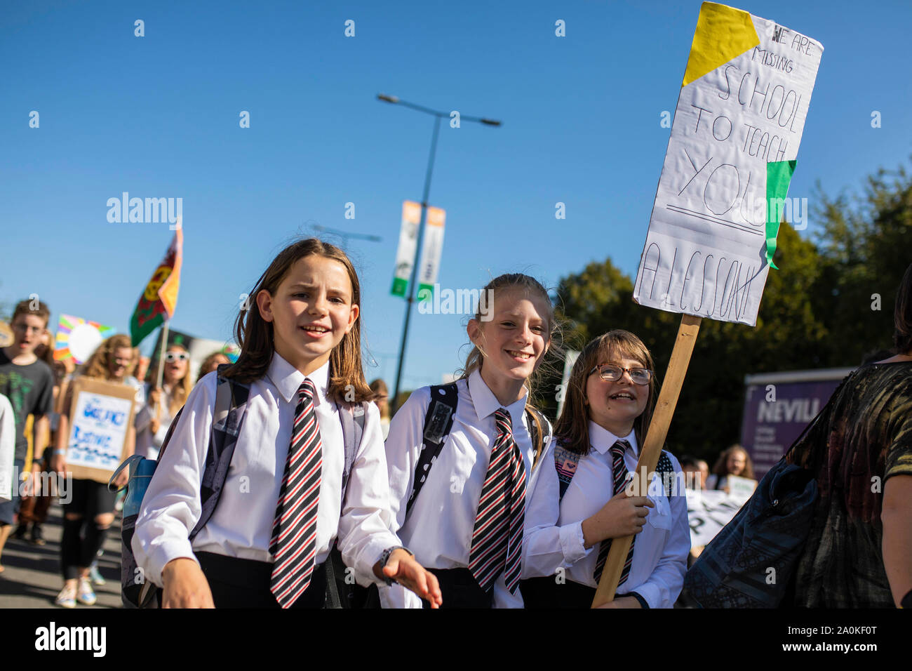 Three schoolgirls in uniform during a protest in Cardiff demanding ...