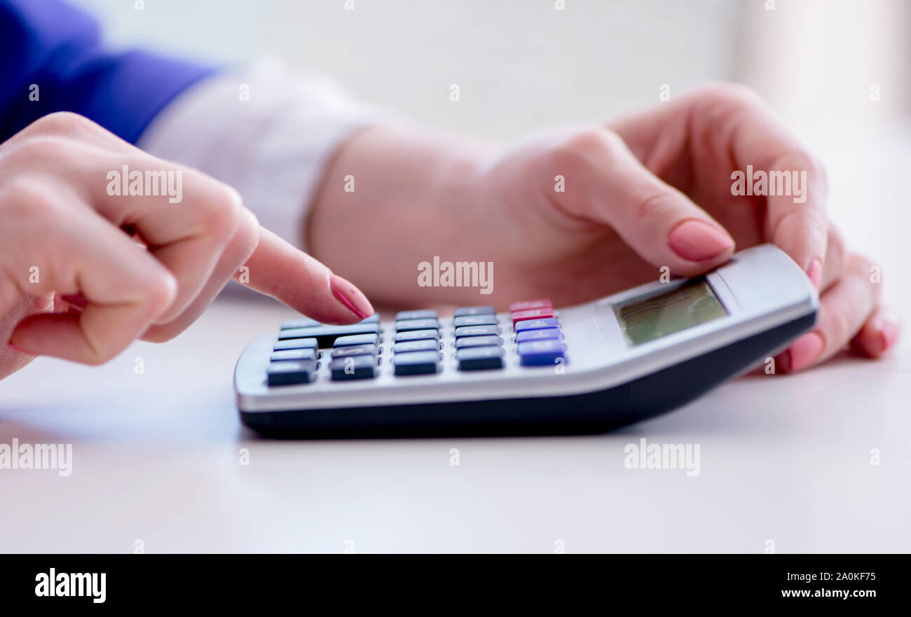 The hands working on accounting calculator calculating profit Stock ...