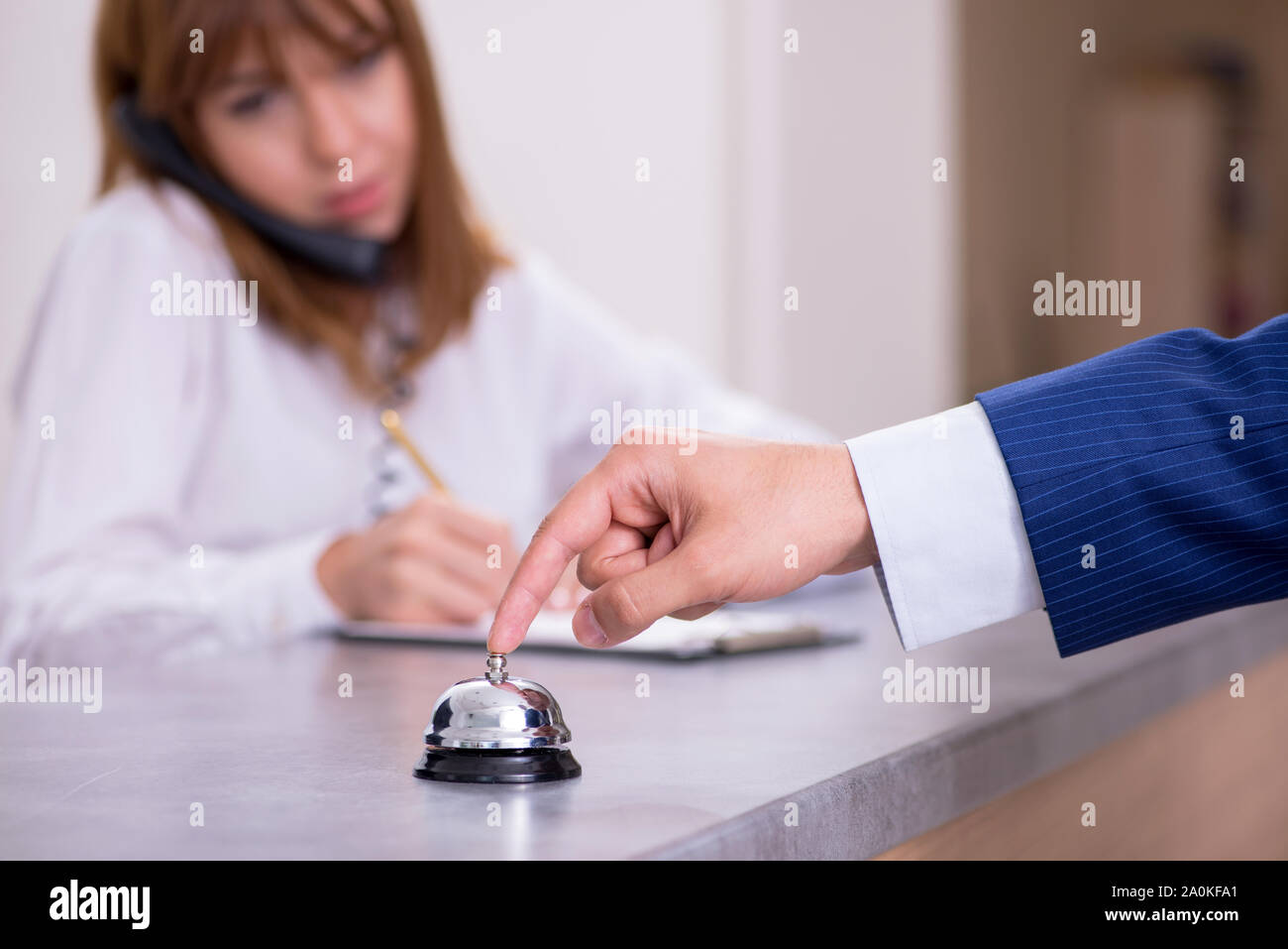 Businessman tourism talking telephone reception counter in hotel hi-res ...