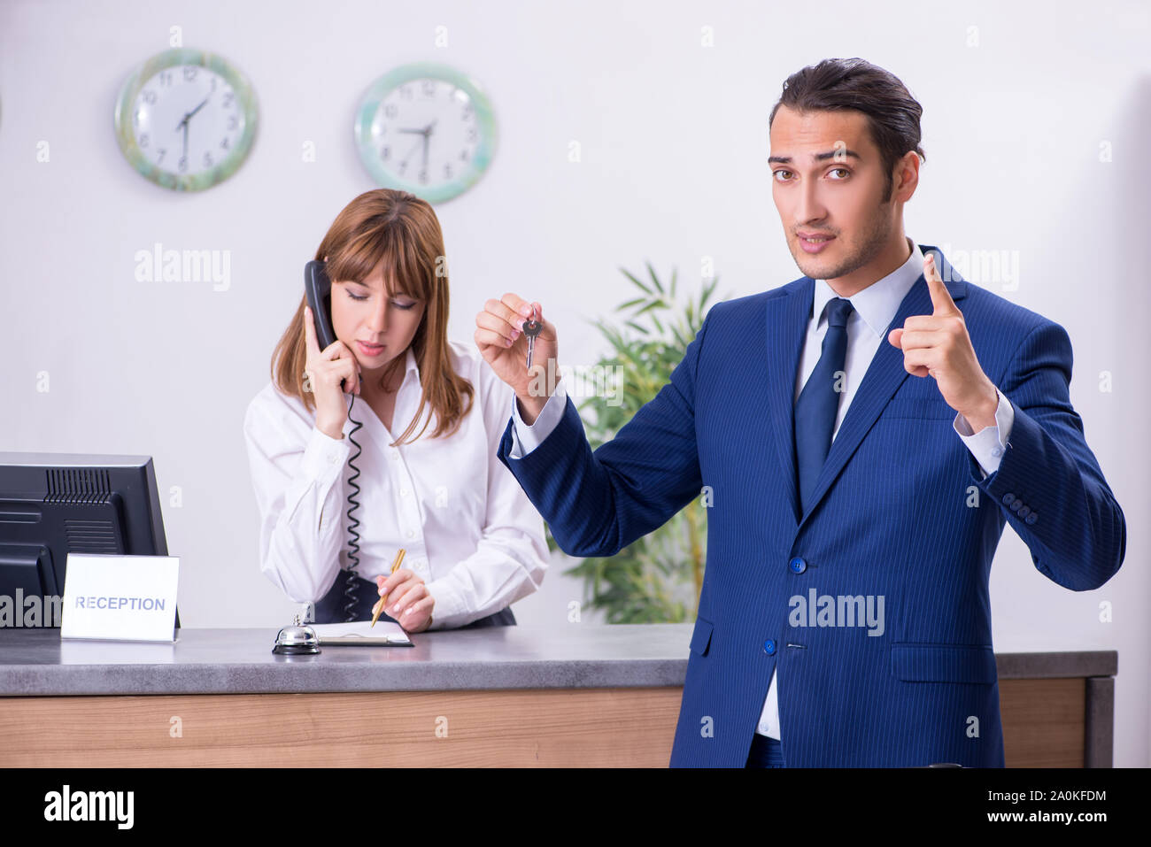 The young businessman at hotel reception Stock Photo - Alamy