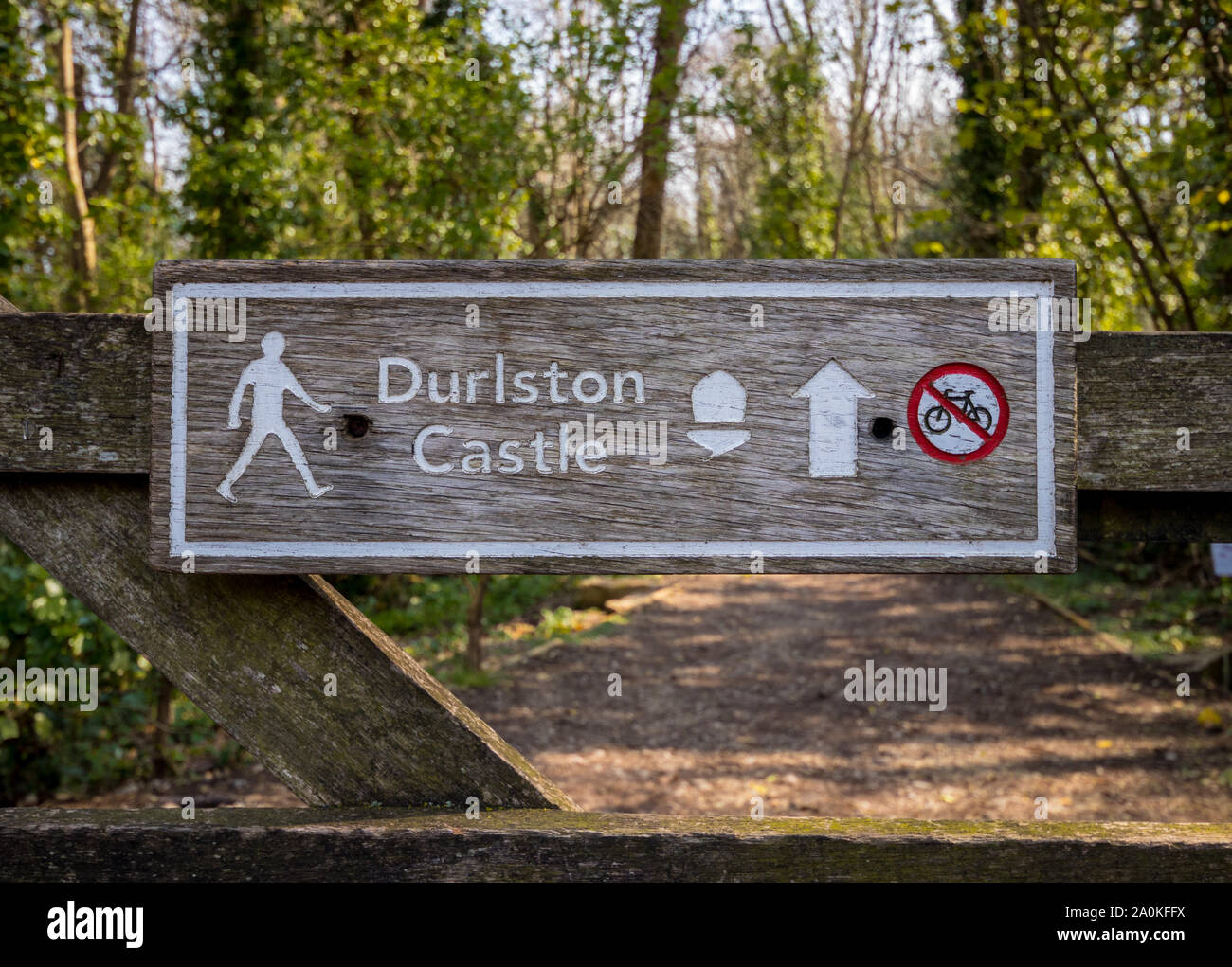 Direction sign to Durlston Castle on a wooden gate at Durlston Country ...