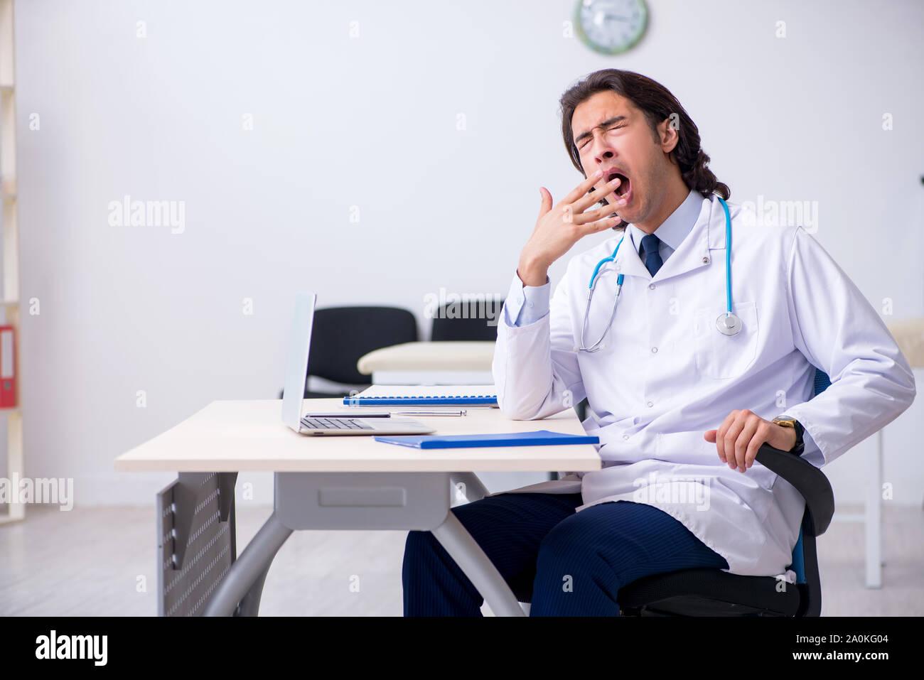 The young doctor being tired after night shift Stock Photo - Alamy