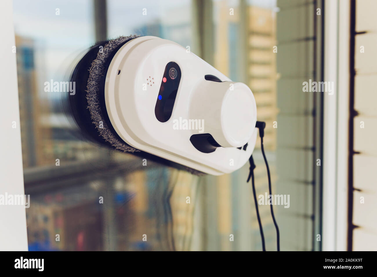 Vacuum cleaner robot cleaning window in high building outdoor Stock ...