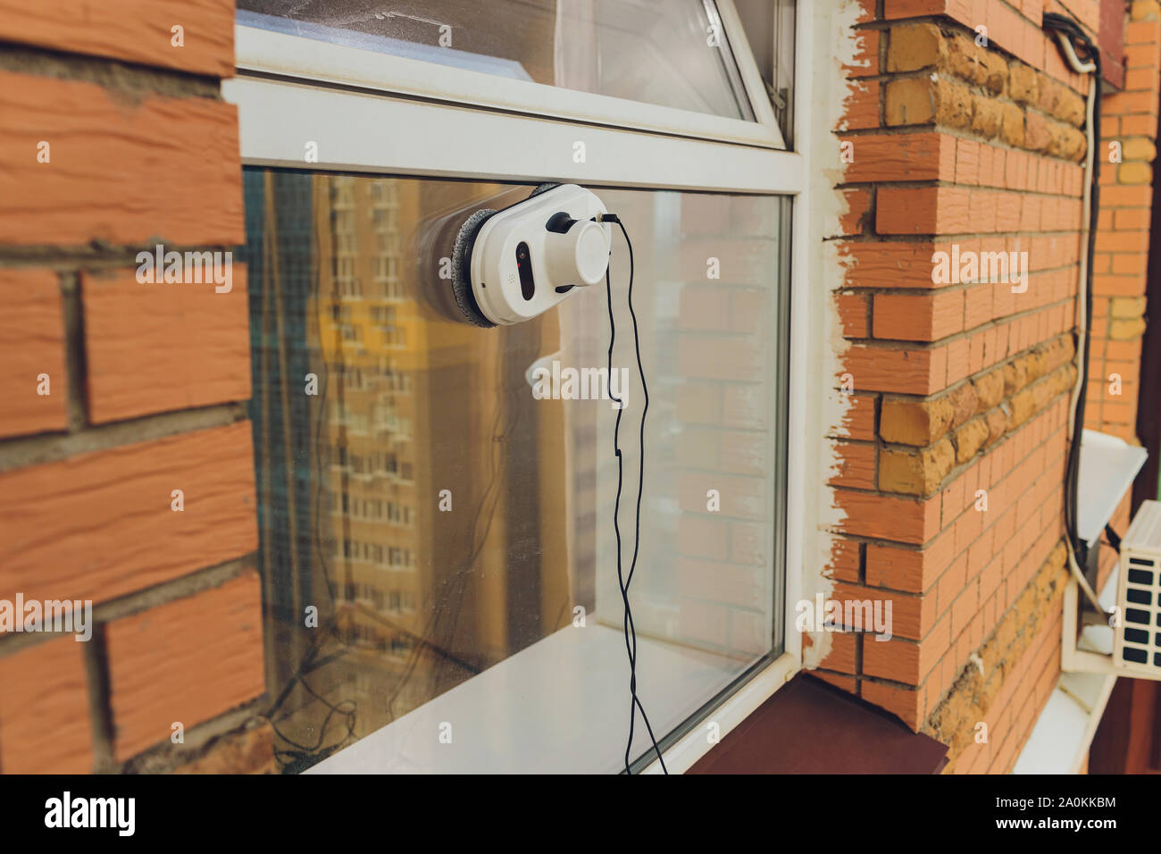 Vacuum cleaner robot cleaning window in high building outdoor Stock ...