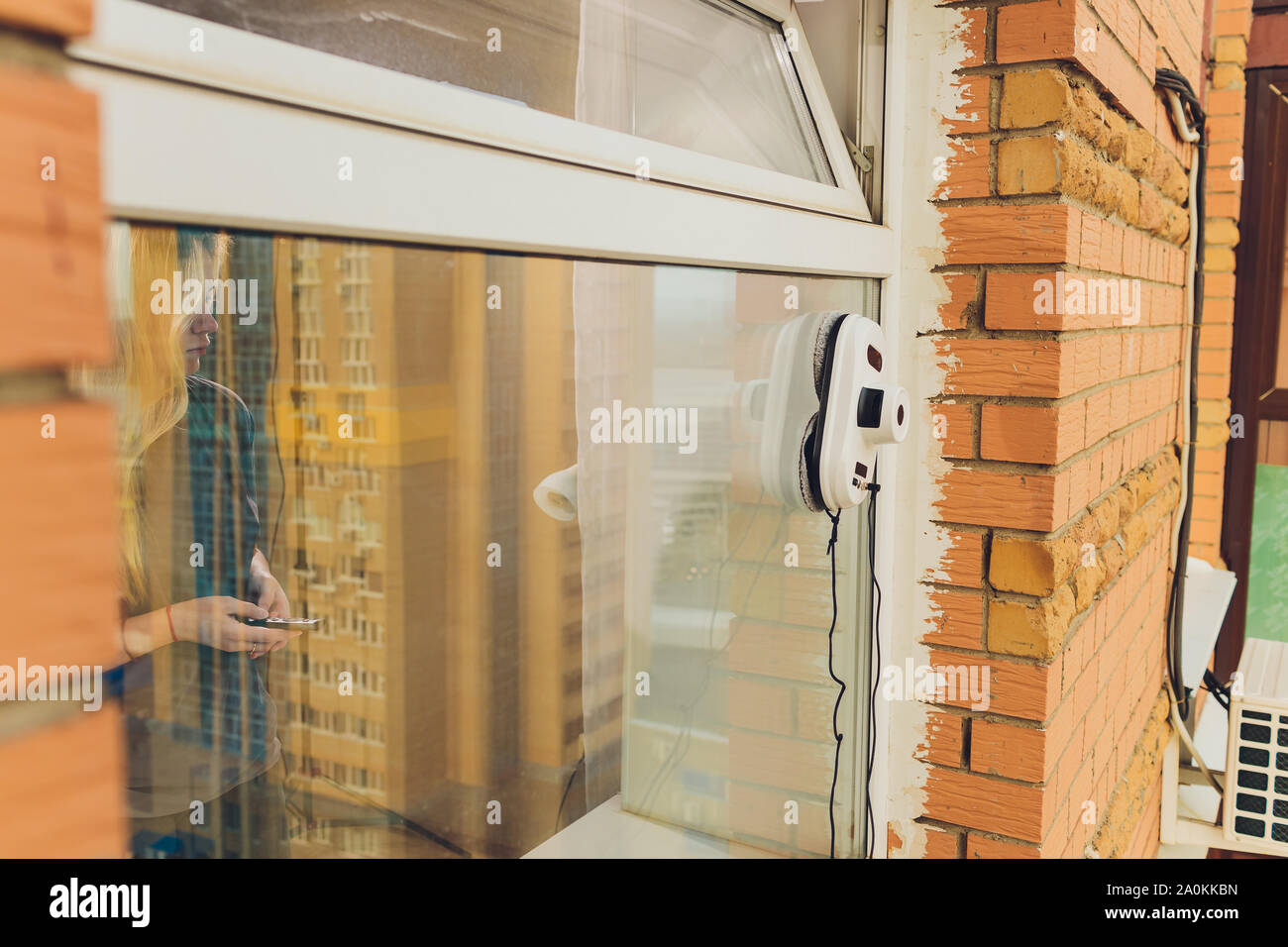 Vacuum cleaner robot cleaning window in high building outdoor Stock ...