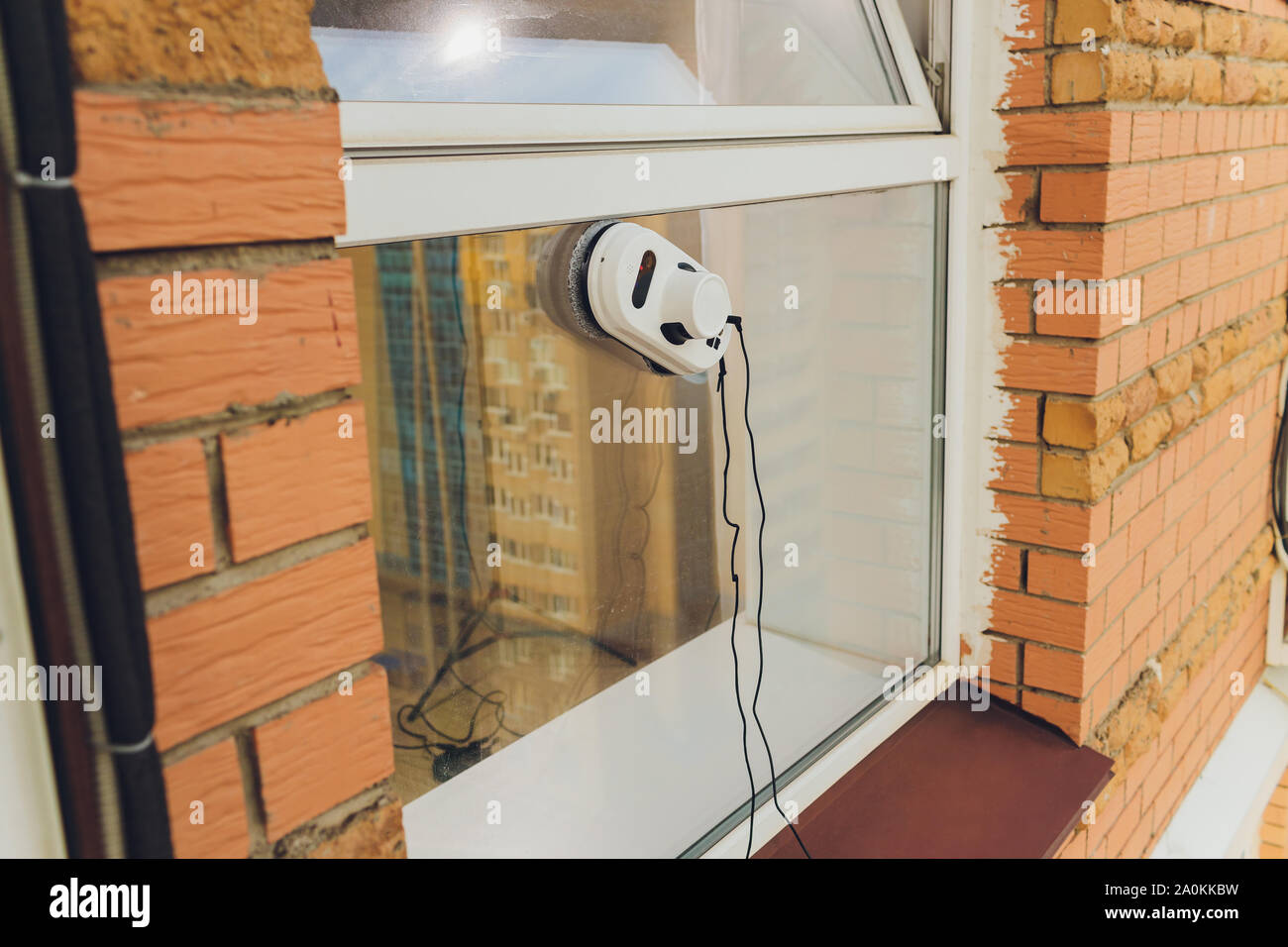 Vacuum cleaner robot cleaning window in high building outdoor Stock ...