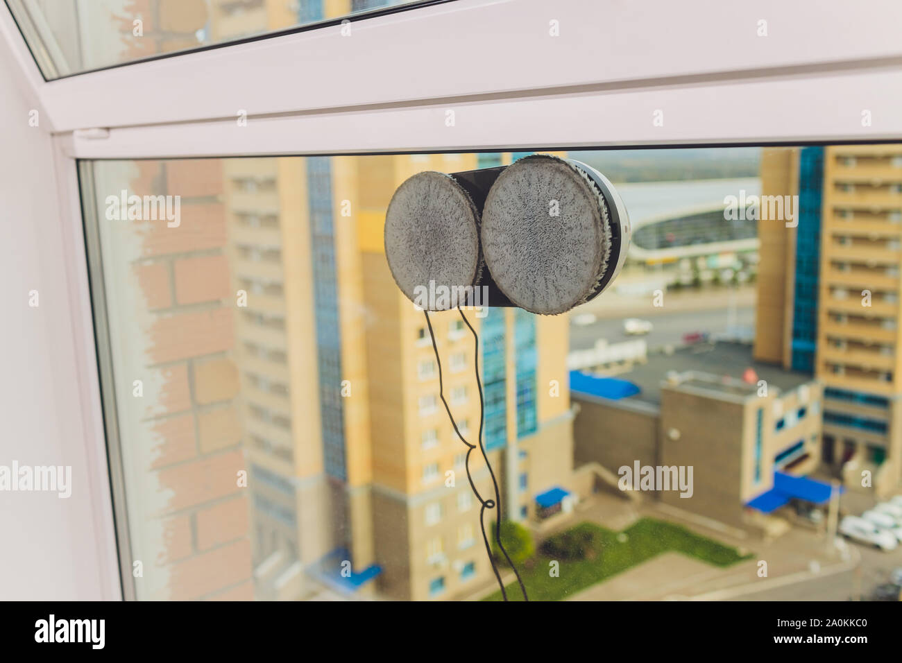 Vacuum cleaner robot cleaning window in high building outdoor Stock ...