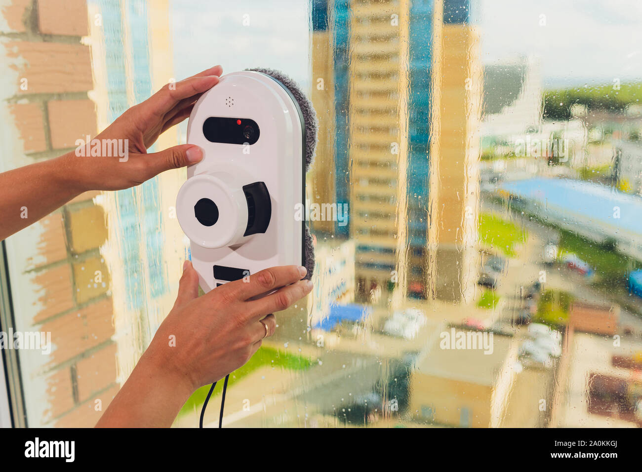 Vacuum cleaner robot cleaning window in high building outdoor Stock ...