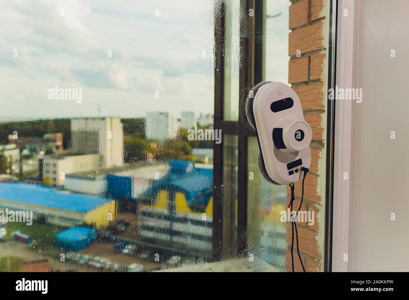 Vacuum cleaner robot cleaning window in high building outdoor Stock ...