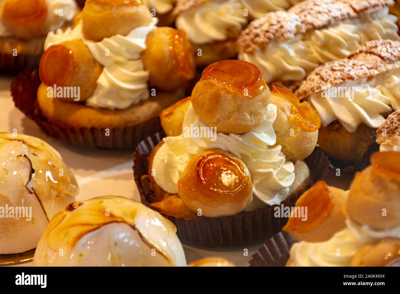 Freshly baked stuffed sweet pastries Orange Lactee and Dome Citron with ...