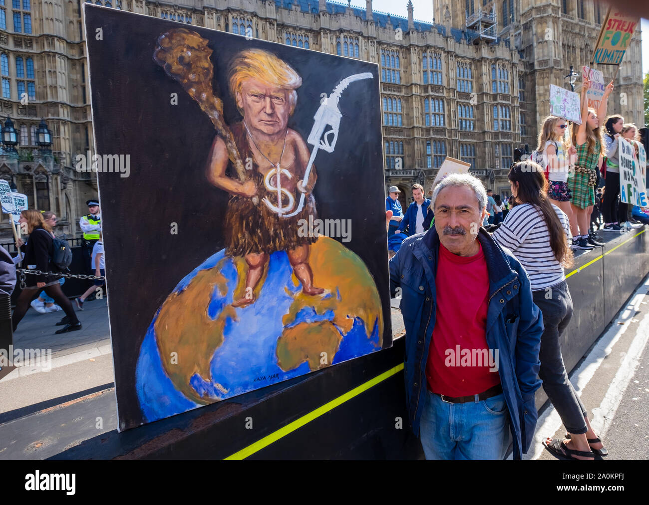 London, UK. 20th September 2019. Political artist Kaya Mar holds one of ...