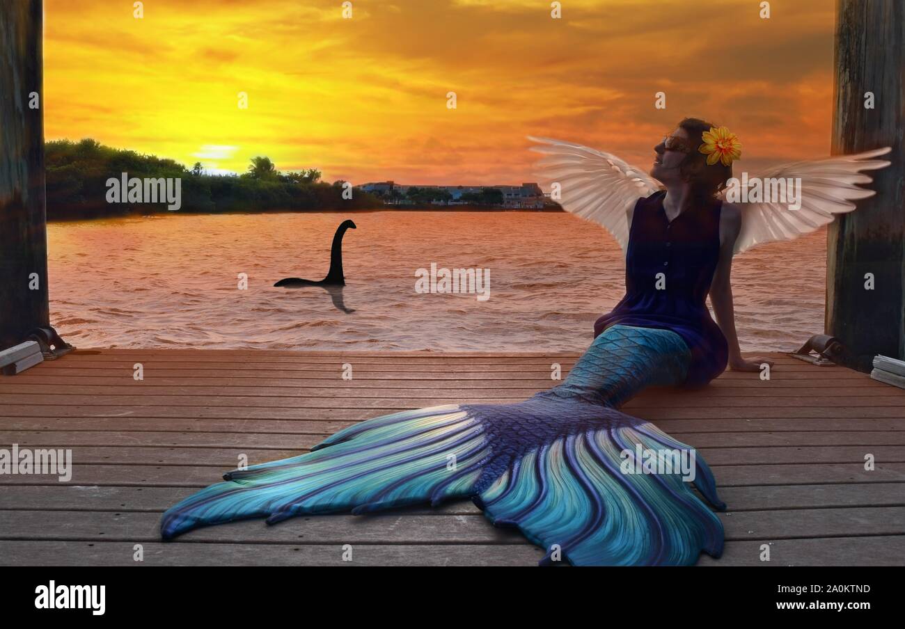 Mermaid on a dock with Angel Wings Stock Photo - Alamy