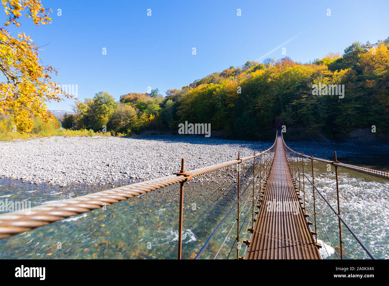 The hanging bridge over mountain river photo Stock Photo - Alamy