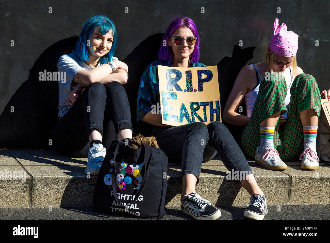 20 September 2019, London, UK - Young teenage girls sitting on ground ...