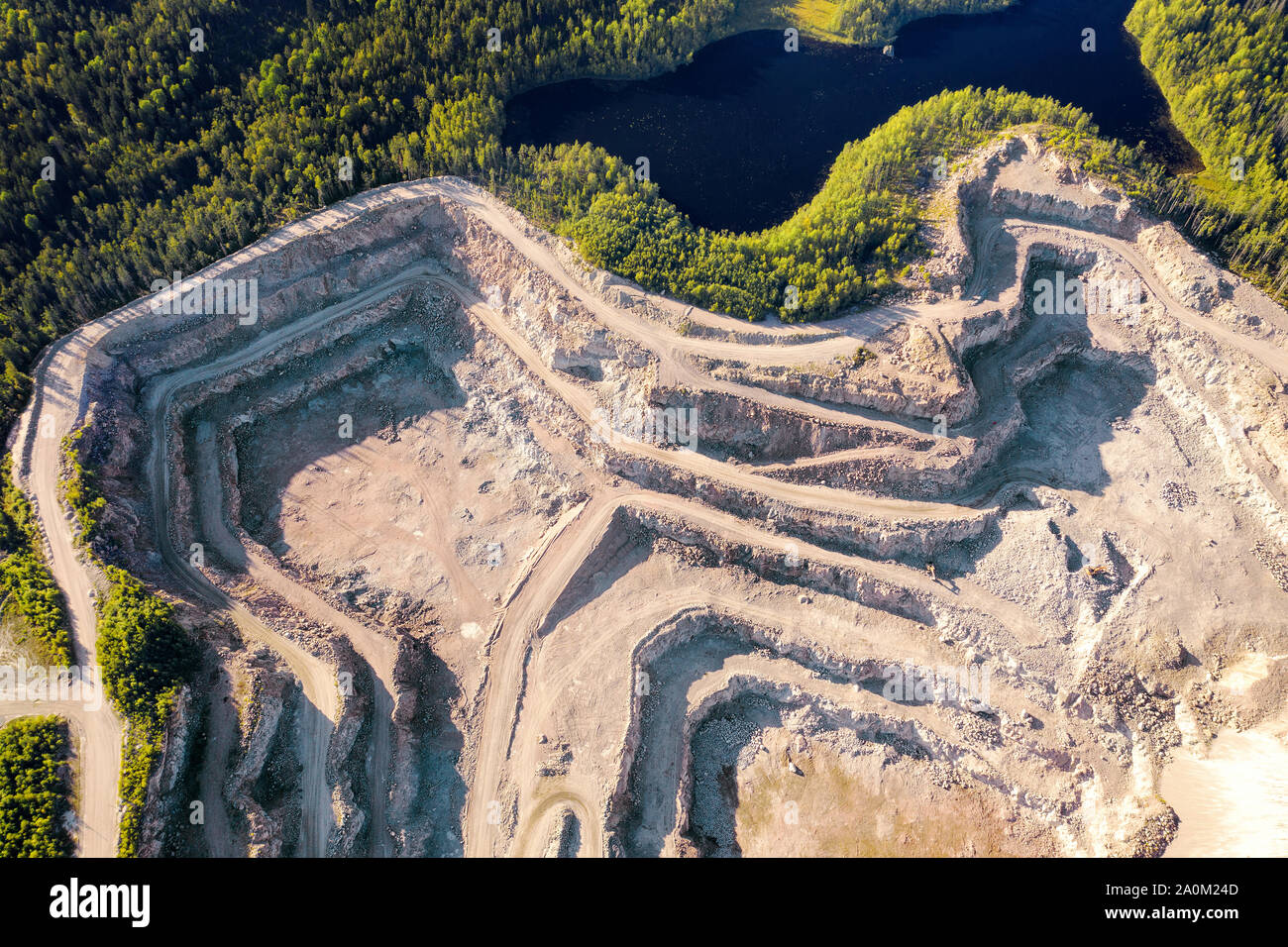Industrial landscape with large granite quarry in the woodland aerial ...