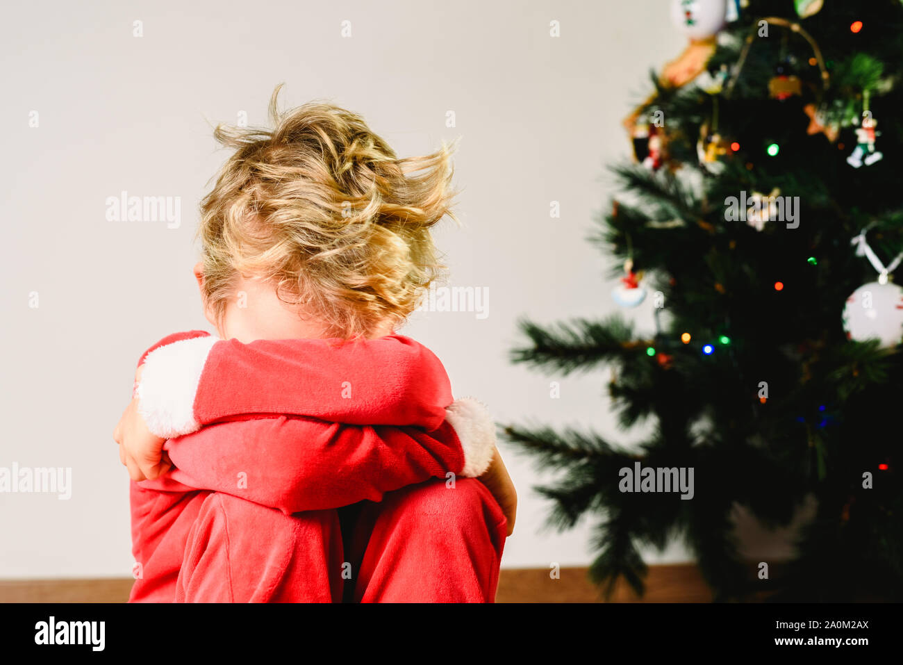 Child with disguise, anxious and sad on Christmas day with an angry ...