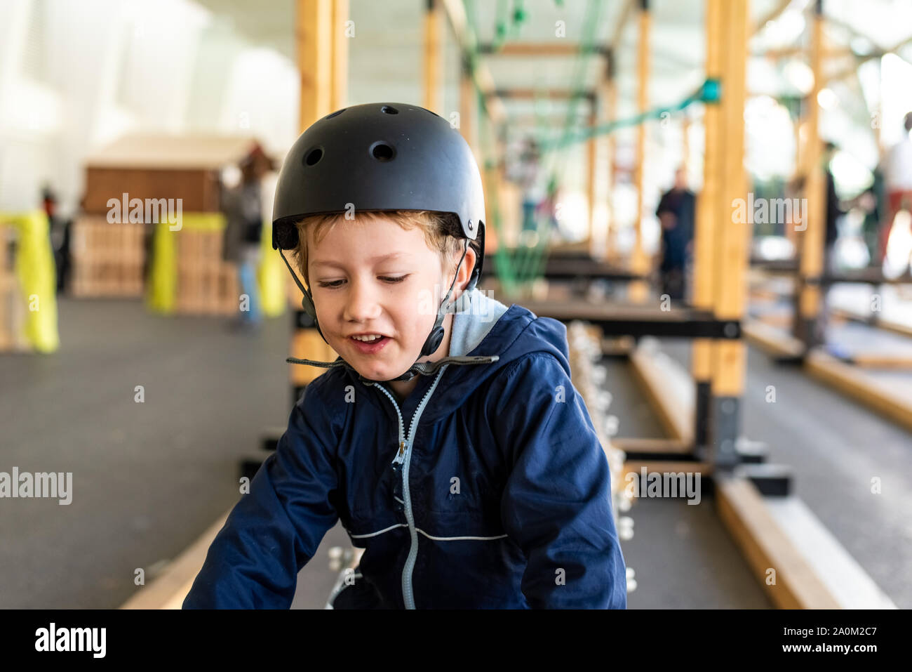 child trying to overcome the obstacles of an adventure park Stock Photo ...