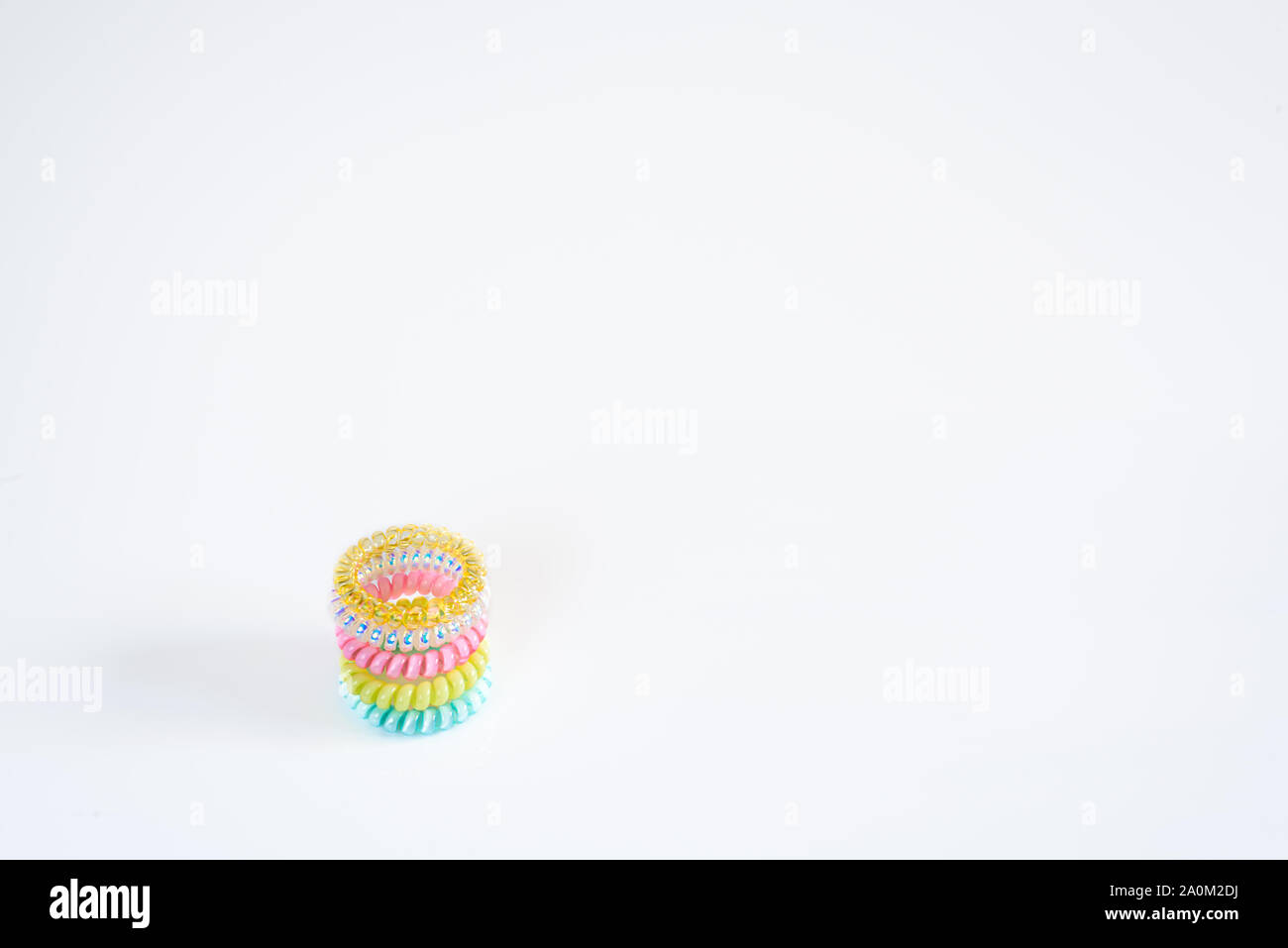 Plastic bracelets of various colors, isolated in a pattern arranged in ...