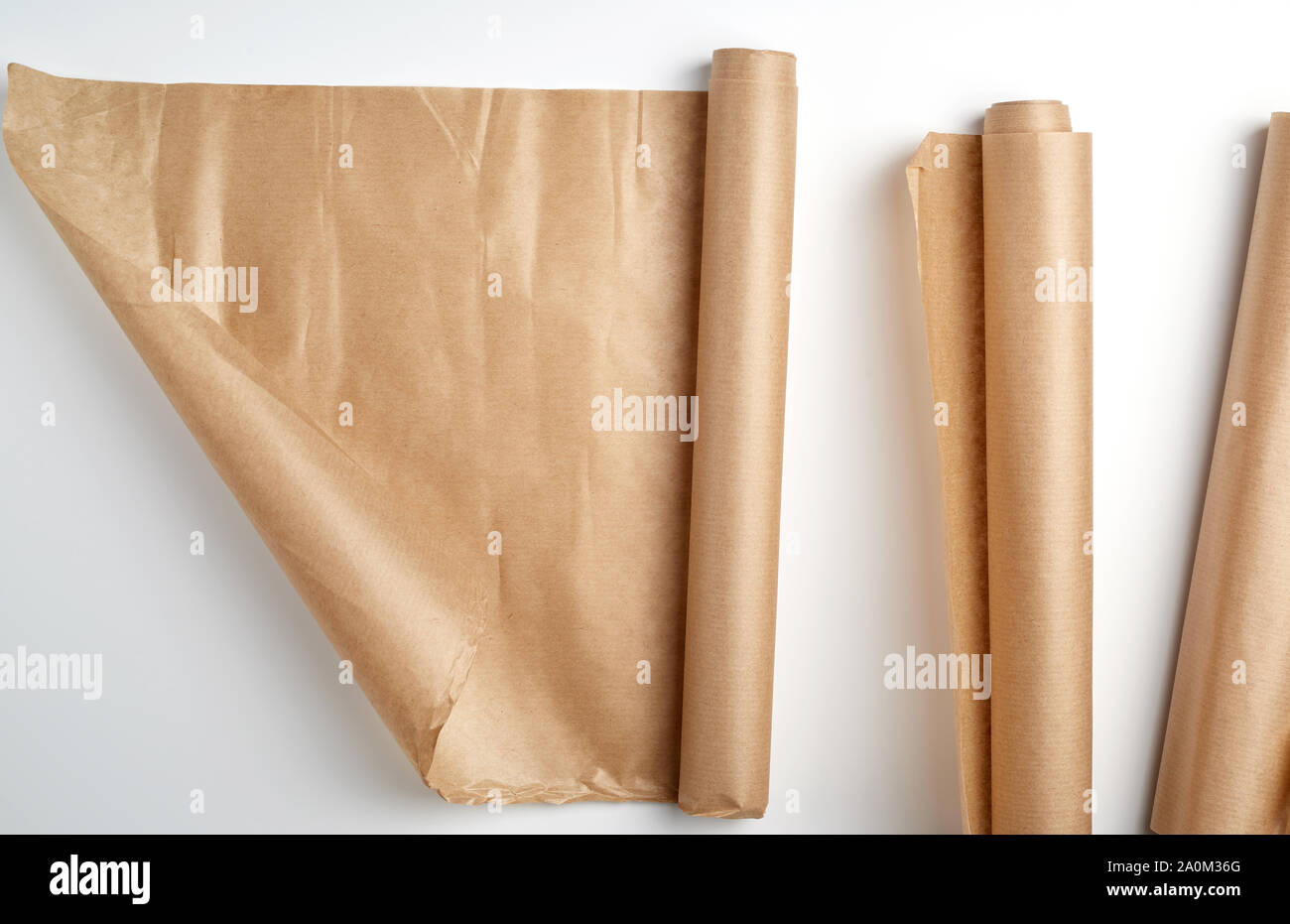 rolled rolls of parchment baking paper on a white background, top view ...