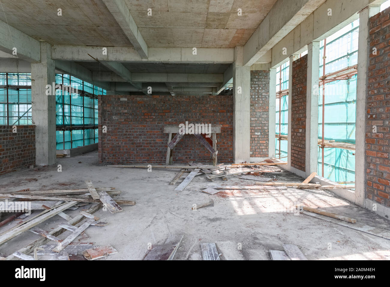 inside of an unfinshed building with protection scaffolding and netting ...